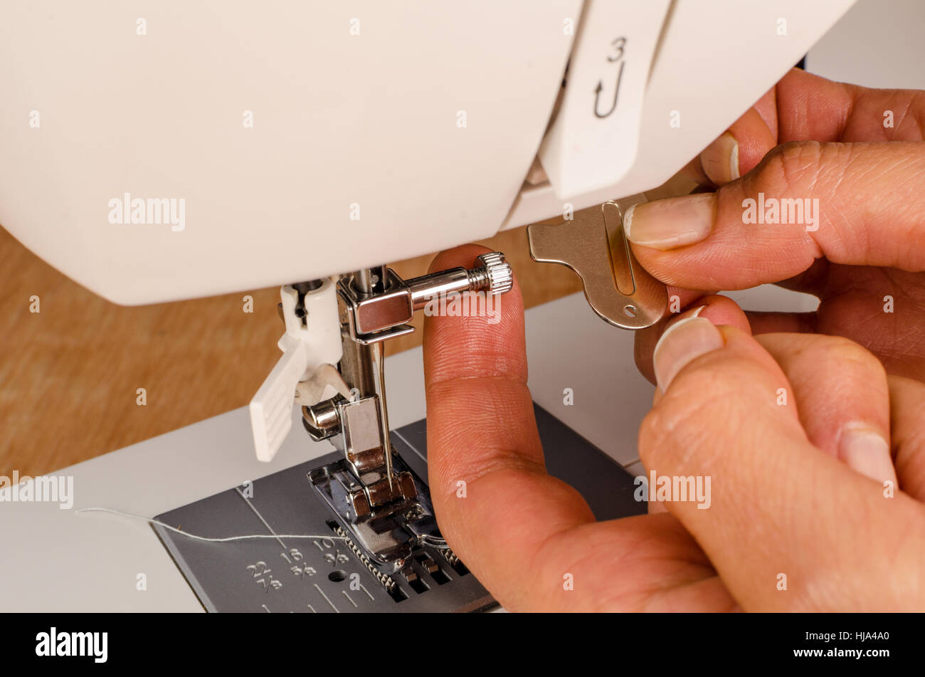 Female hands doing maintenance work on a domestic sewing machine Stock ...