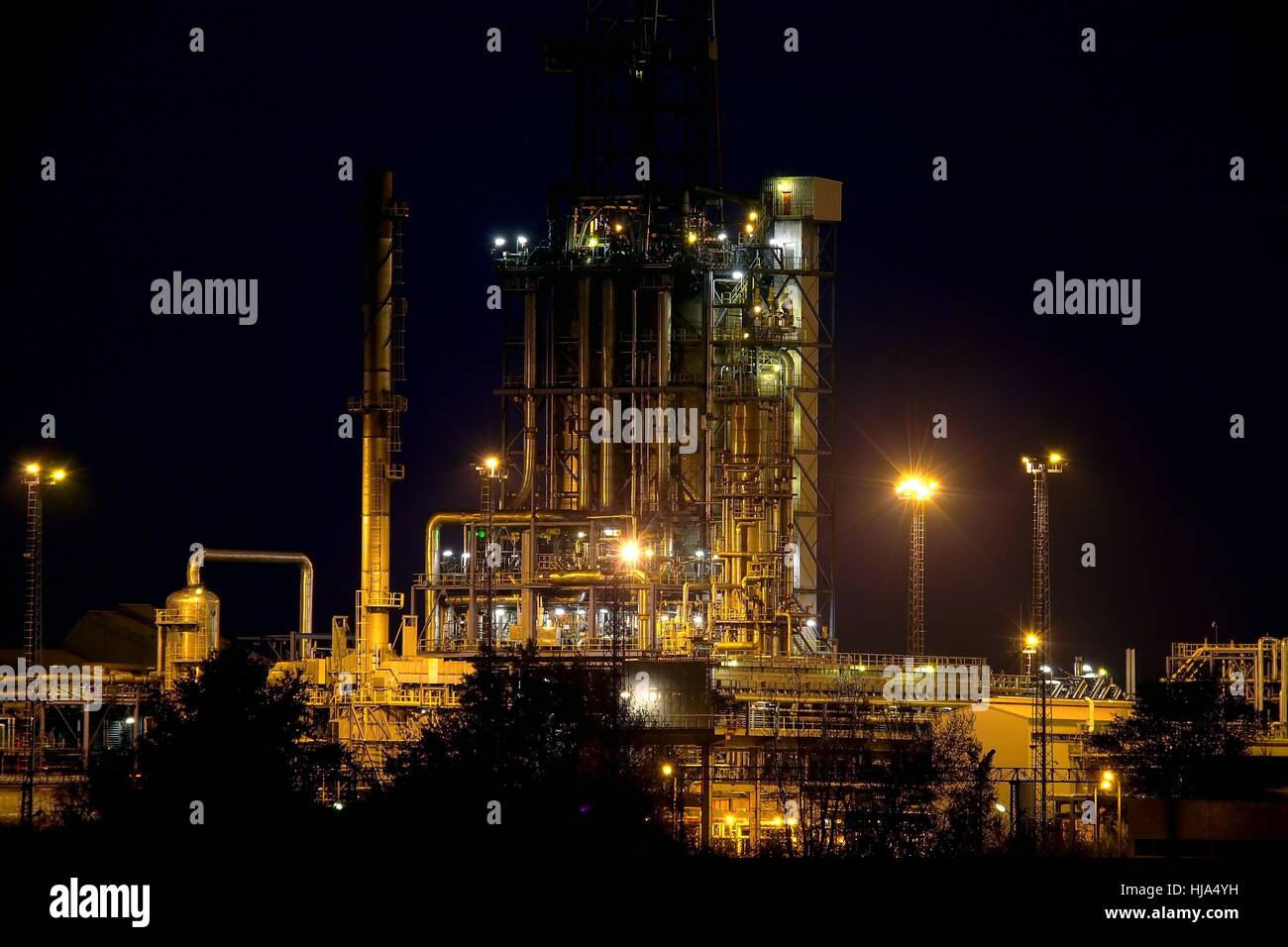 Oil refinery building at night Stock Photo - Alamy