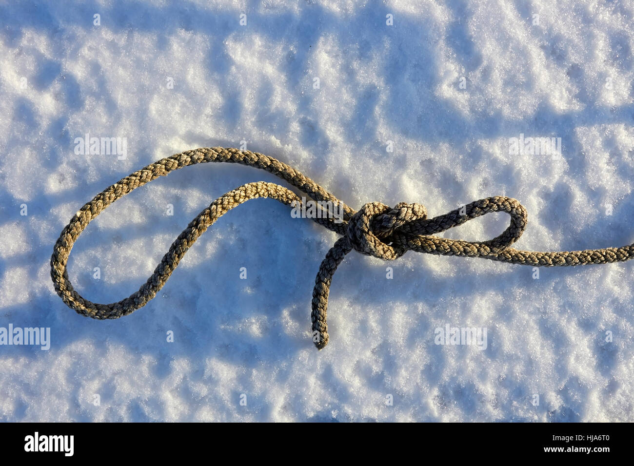 old rope on ground Stock Photo - Alamy