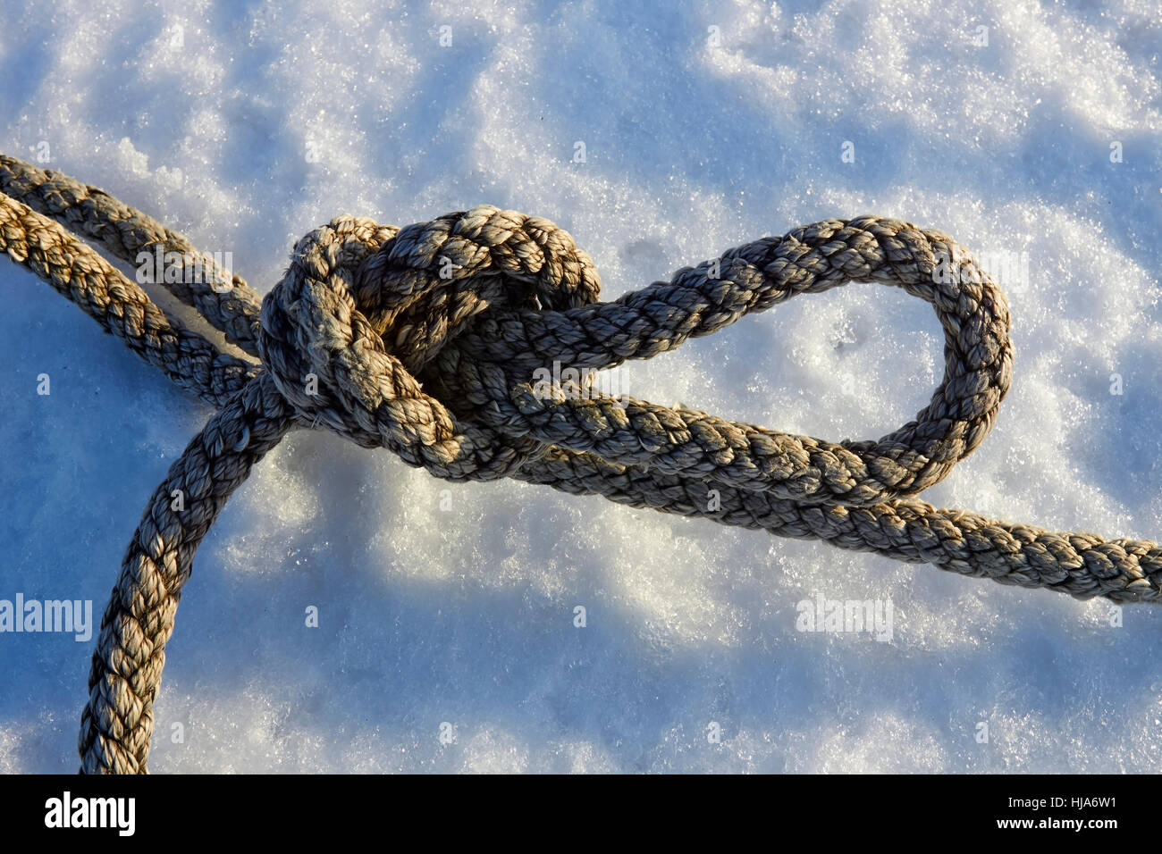 old rope on ground Stock Photo - Alamy