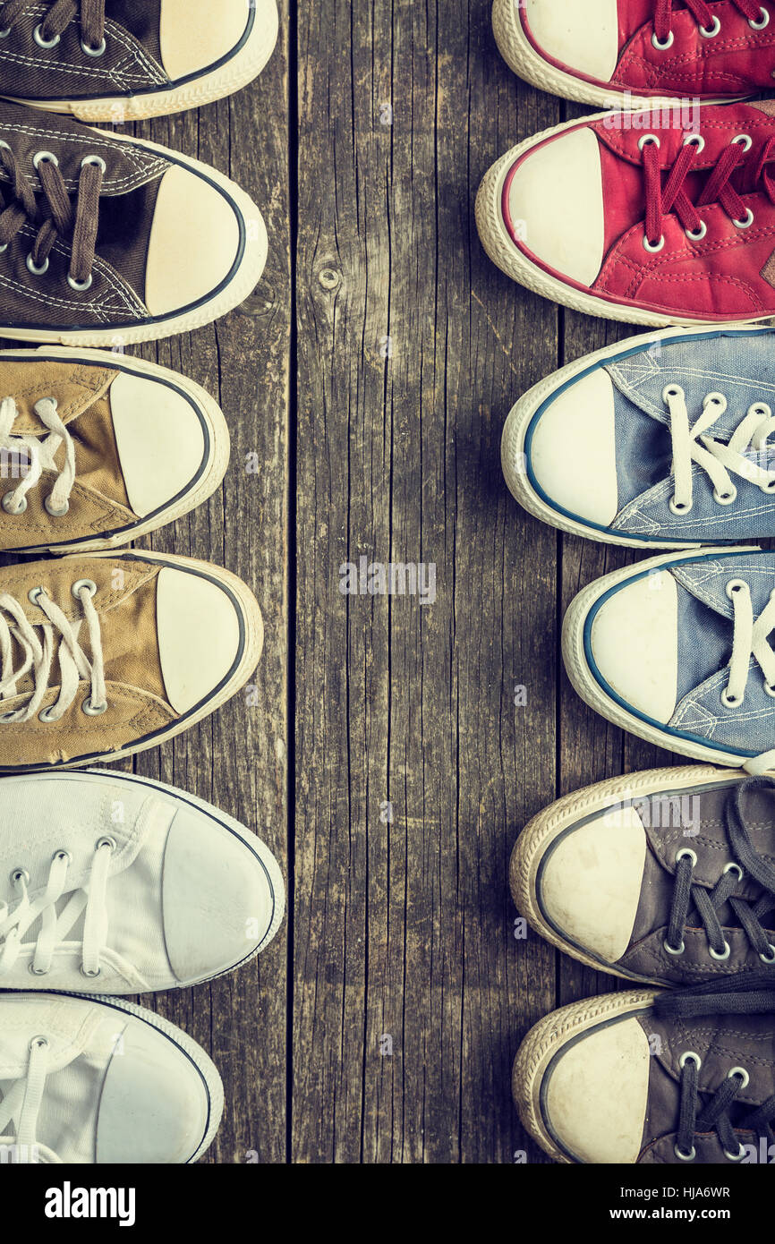 The vintage sneakers on old wooden table. Top view Stock Photo - Alamy