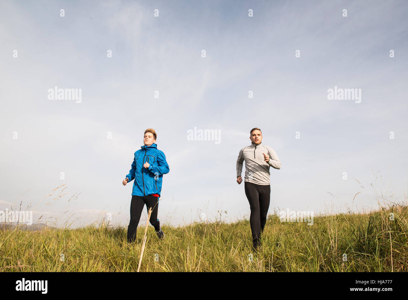 Two young hipster athletes running in sunny autumn nature Stock Photo ...