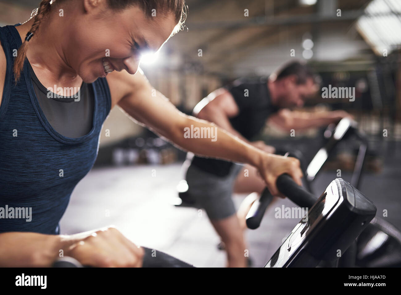 Hard working sportive people doing cardio on exercycle. Horizontal ...