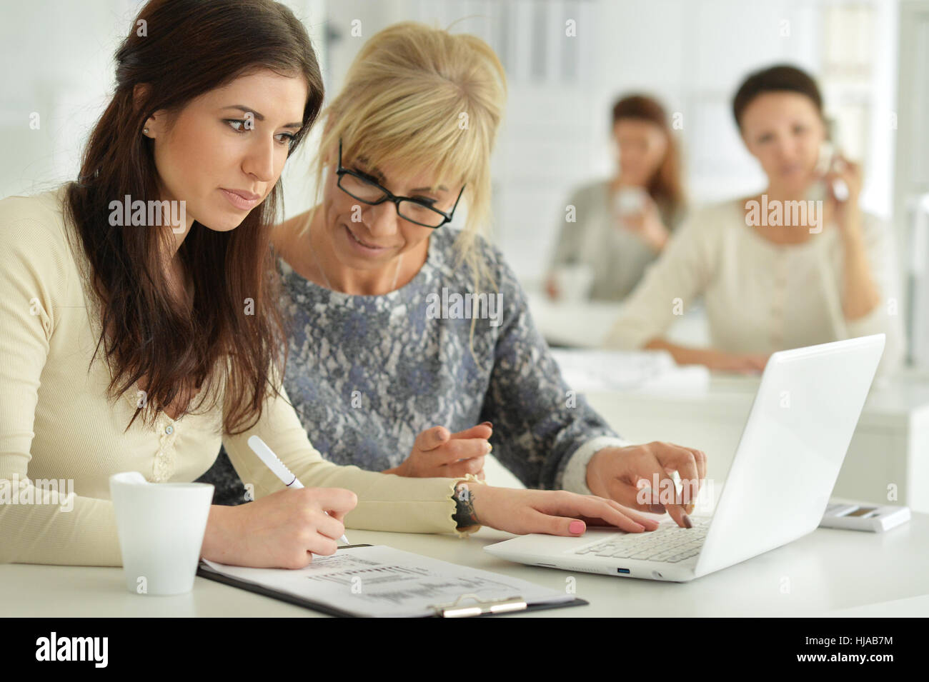young women working at office Stock Photo - Alamy