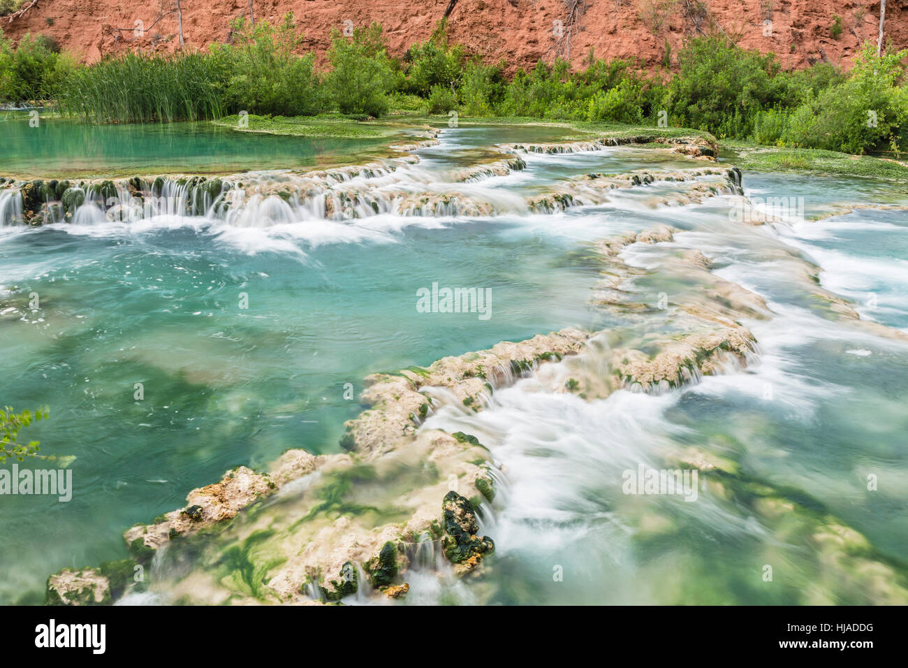 The crystal clear turquoise waters of Havasu Creek flow over travertine ...