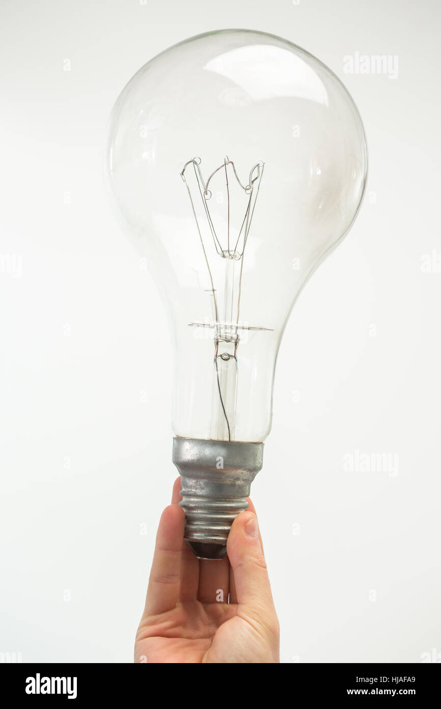 Man holding big light bulb at his fingertips close up on white ...