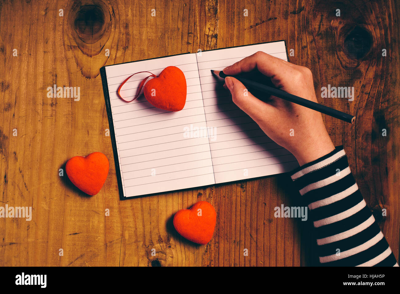 Woman writing love letter card for Valentines day, top view of female ...