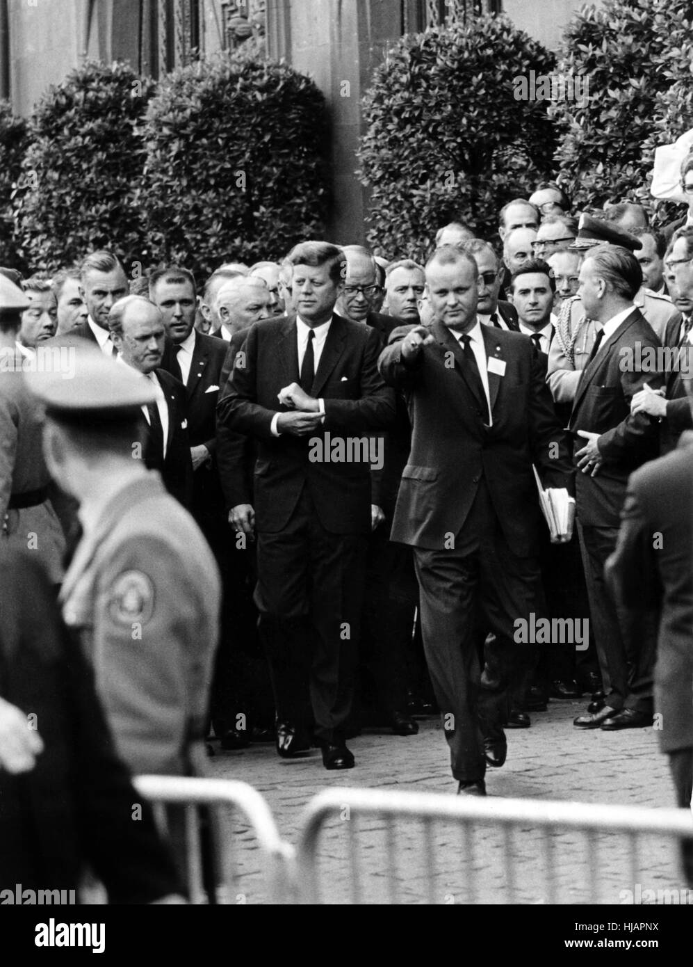 US President John F. Kennedy is welcomed by an excited crowd of people ...