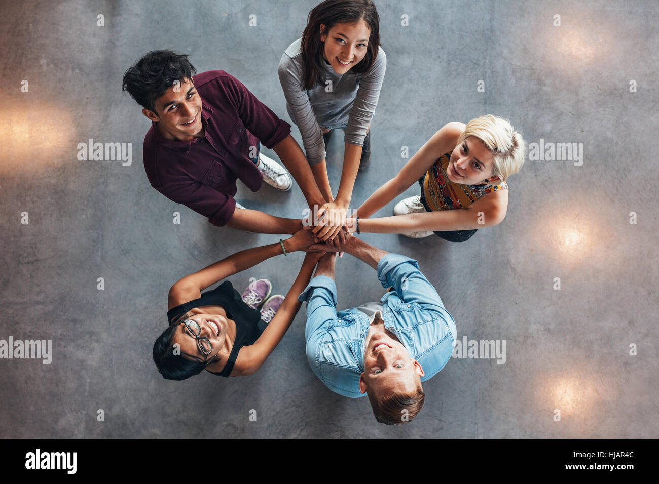 Group of happy young students showing unity. Top view of multiethnic ...