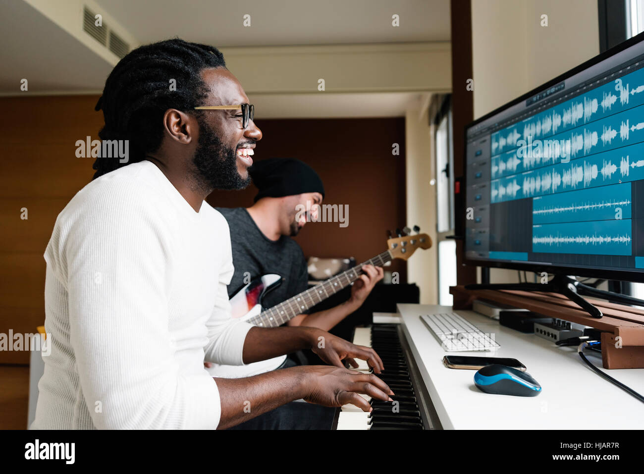 Artists producing music in their home sound studio Stock Photo - Alamy