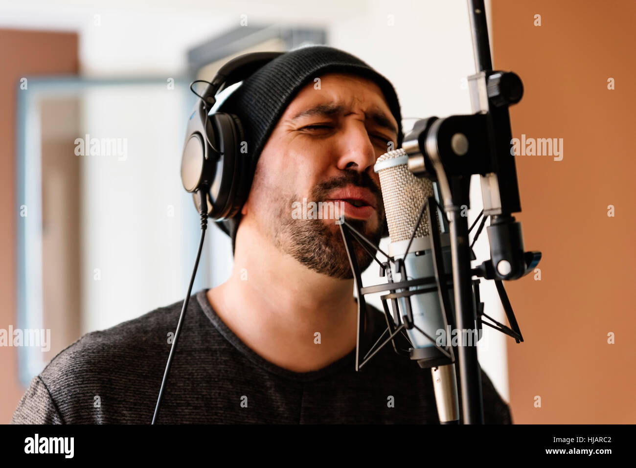 Young man singing on musical studio Stock Photo - Alamy