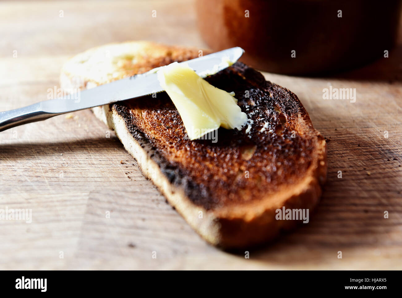 Slices of burnt white toast with knife and butter Stock Photo - Alamy