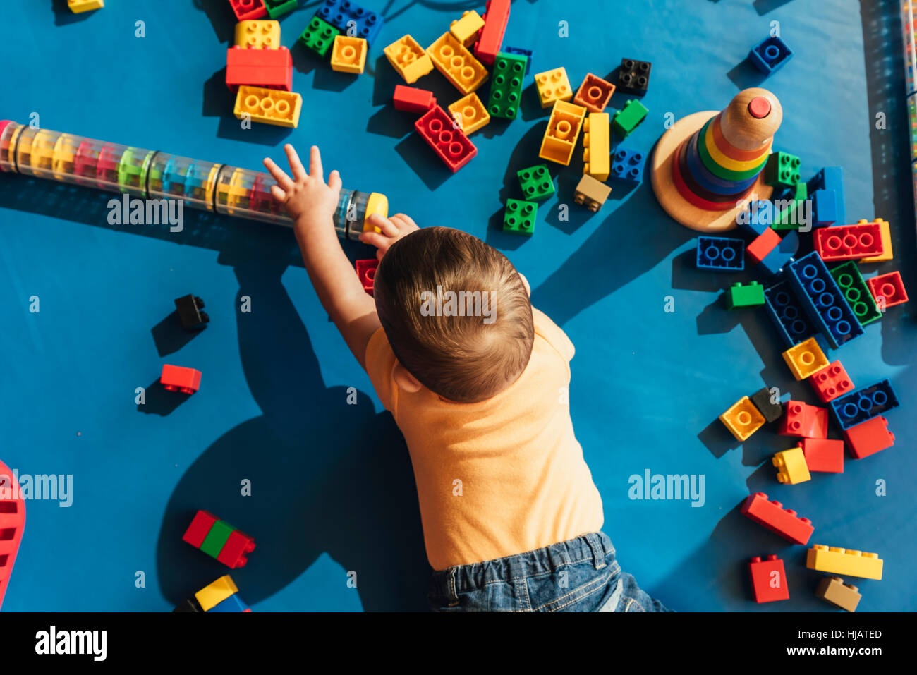 Happy baby playing with toy blocks in the kindergarten Stock Photo - Alamy
