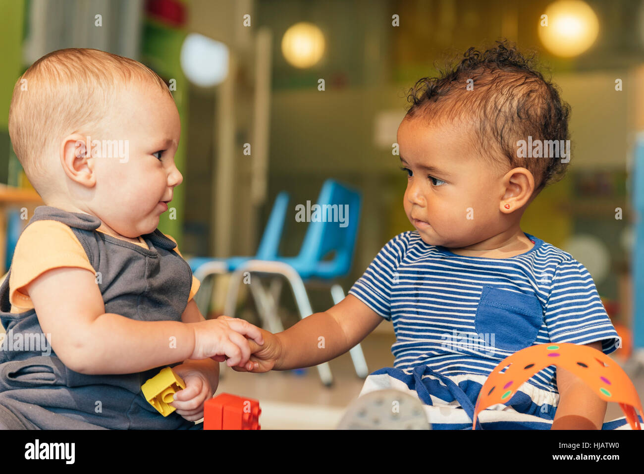 Babys playing together in the kindergarten Stock Photo - Alamy