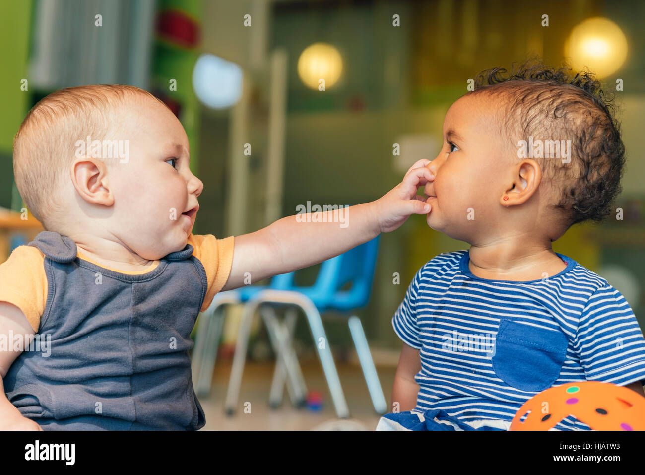 Babys playing together in the kindergarten Stock Photo - Alamy