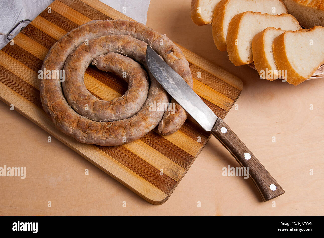 Roasted traditional homemade sausage with spices and herbs on wooden ...