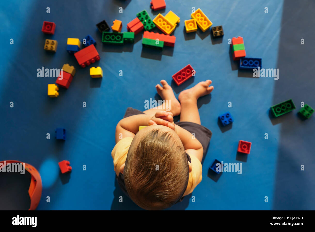 Happy baby playing with toy blocks in the kindergarten Stock Photo - Alamy