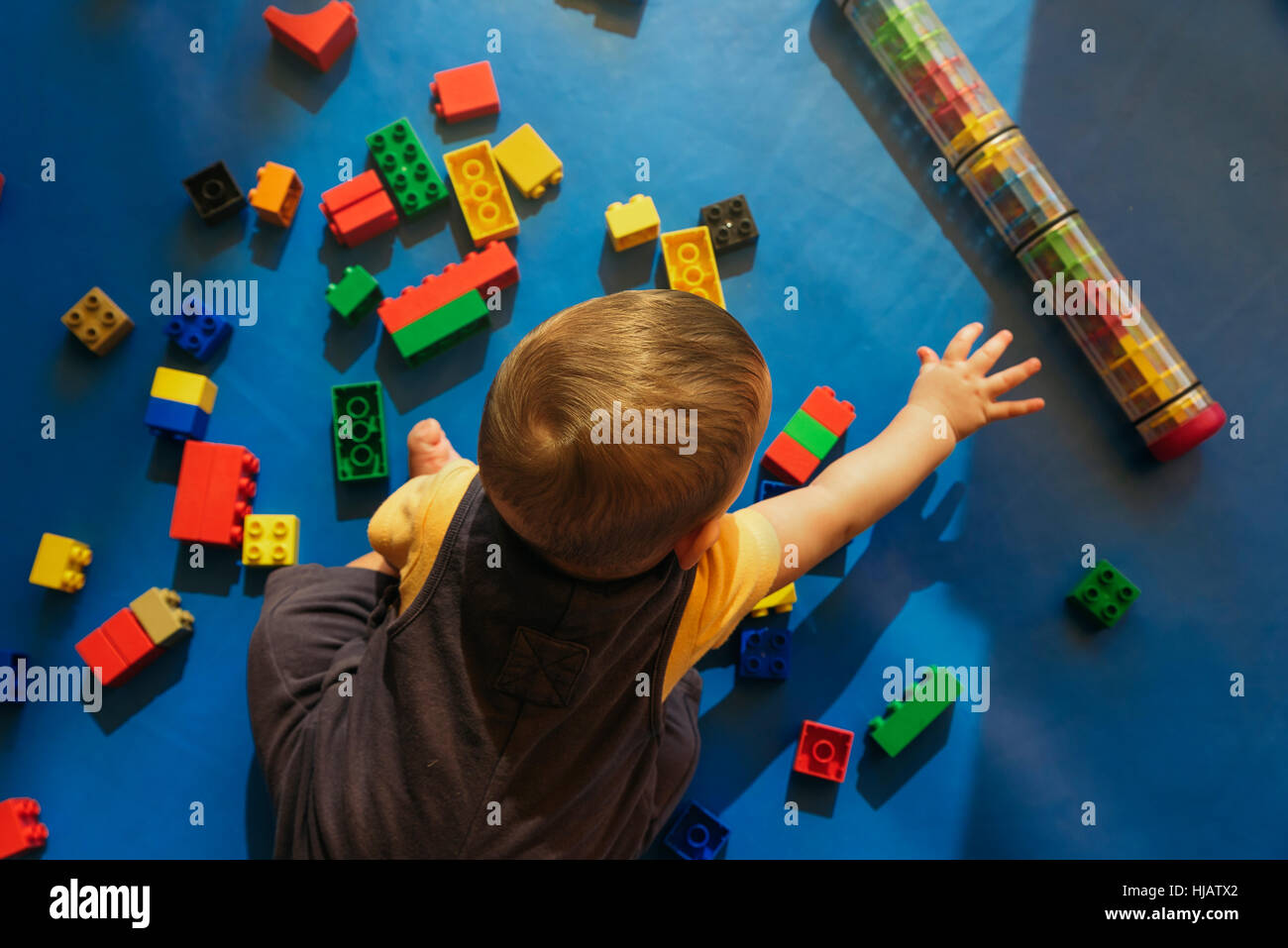 Happy baby playing with toy blocks in the kindergarten Stock Photo - Alamy