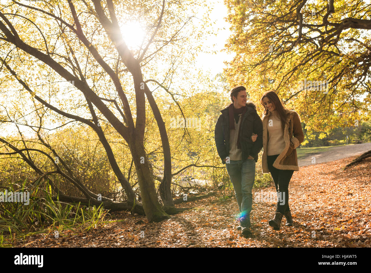 Young couple walking arm in arm hi-res stock photography and images - Alamy