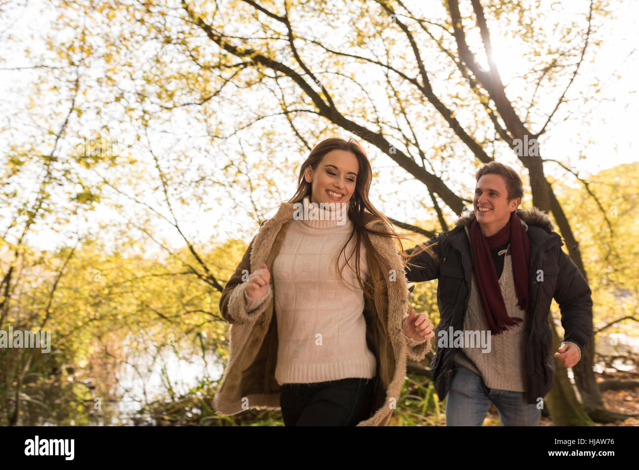 Young woman running around tree hi-res stock photography and images - Alamy