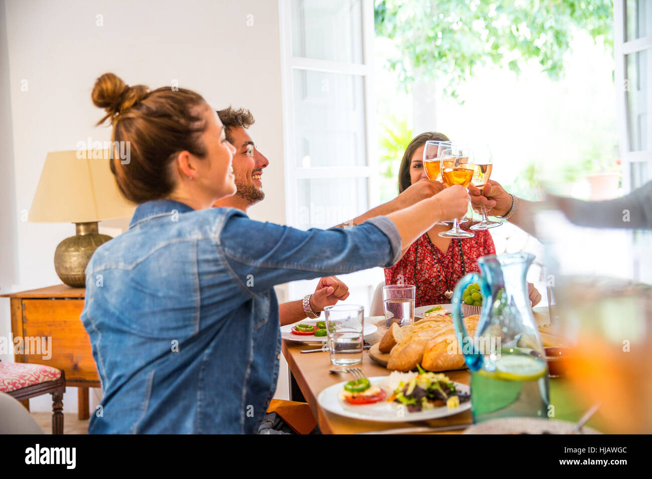Friends dining together, making a toast Stock Photo - Alamy