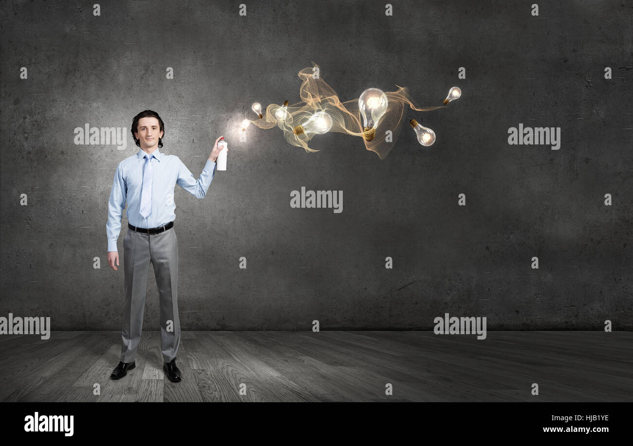 Concept of creativity with businessman spraying light bulbs from ...