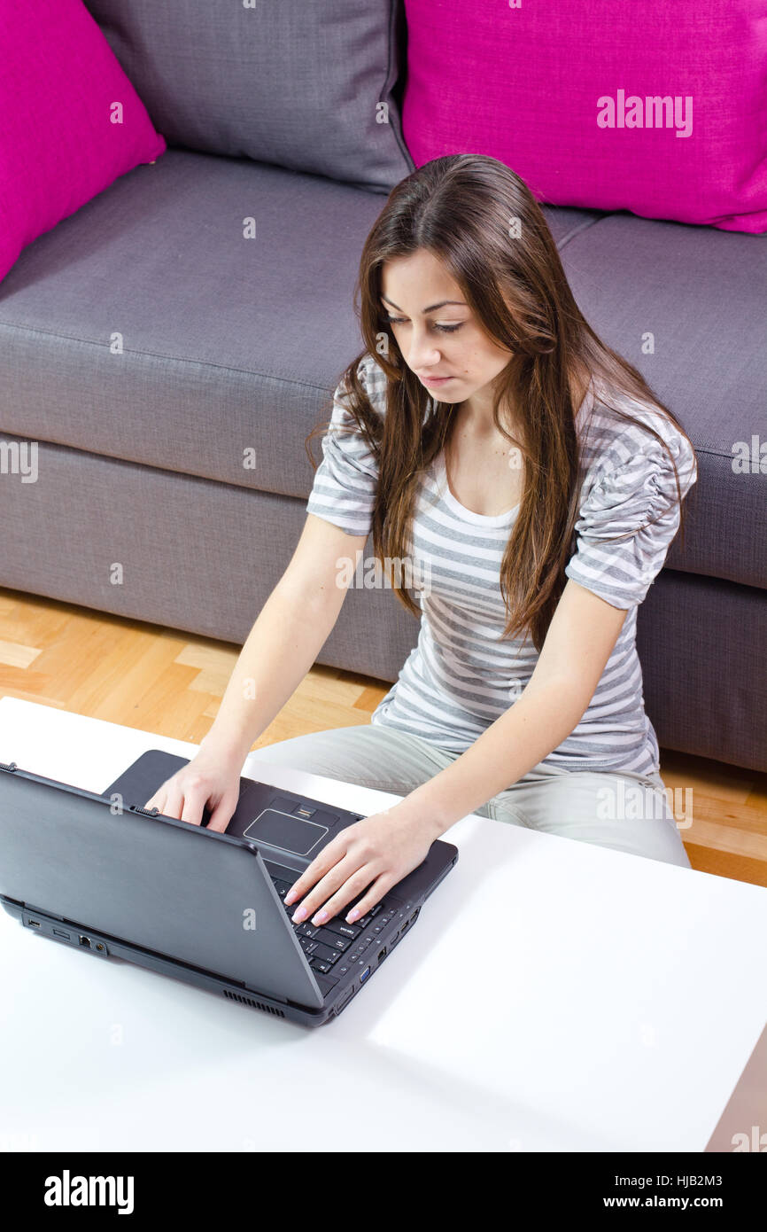 Pretty girl sitting using laptop cute smile teen hi-res stock ...