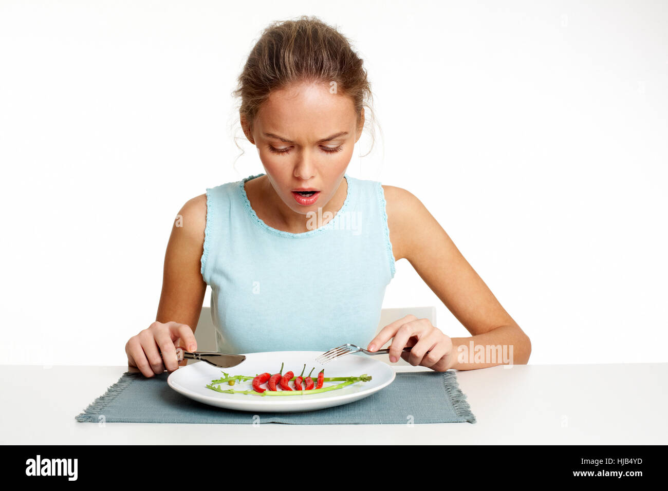Young woman being shocked with her spicy diet Stock Photo - Alamy
