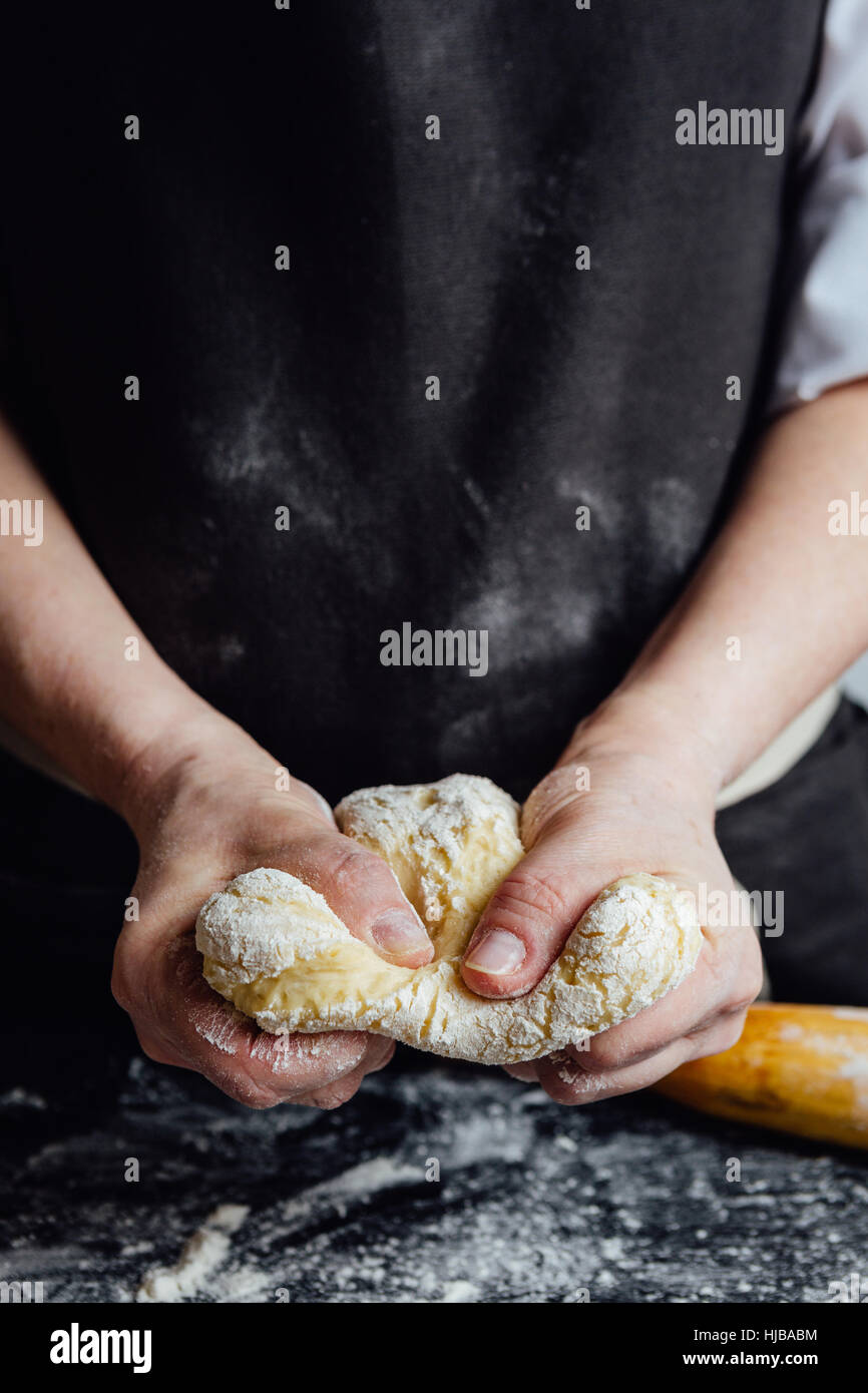 Hands of cook beating up pastry for cookies. Vertical studio shot Stock ...