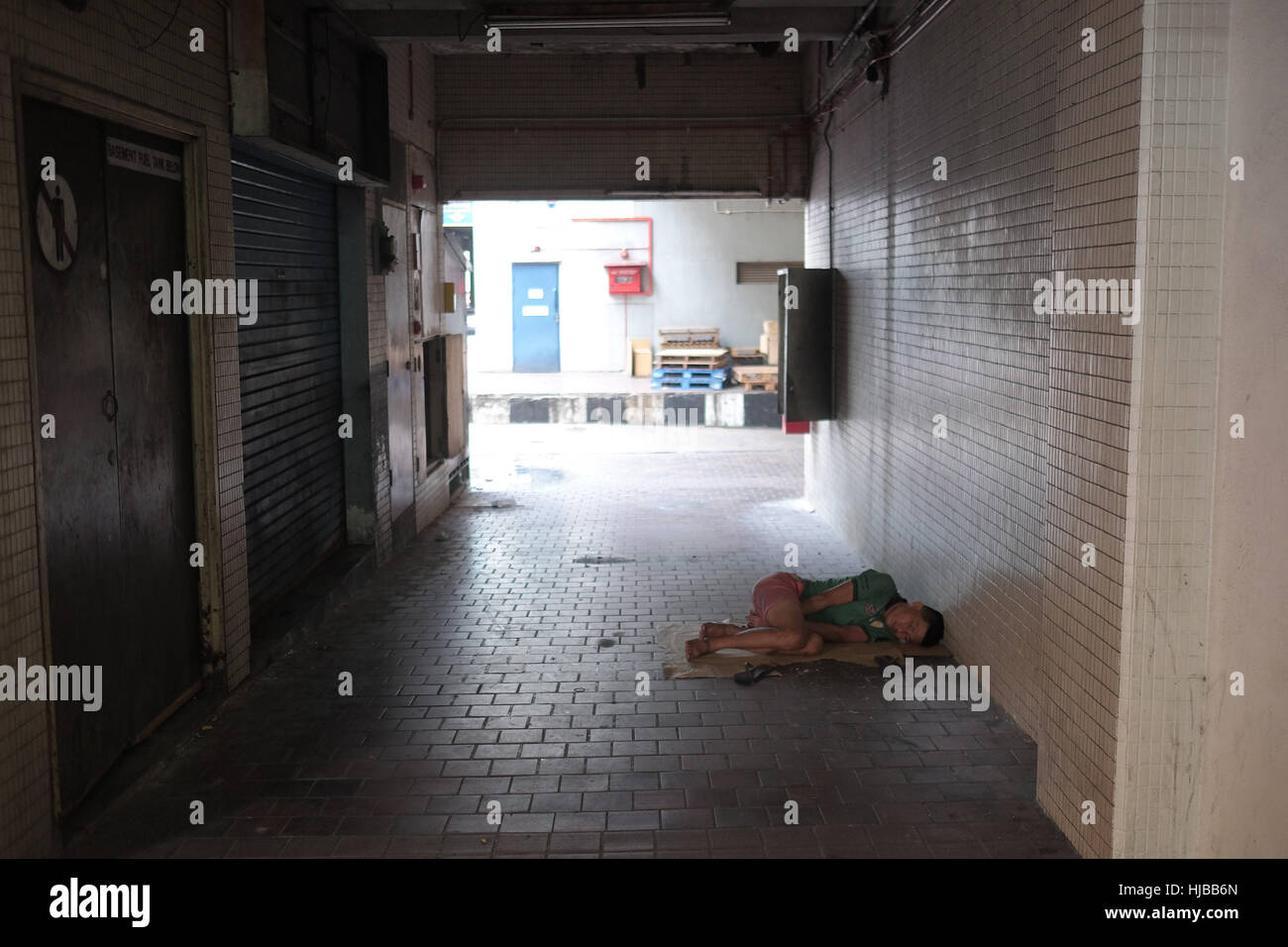 homeless man sleeping at pathway Stock Photo - Alamy