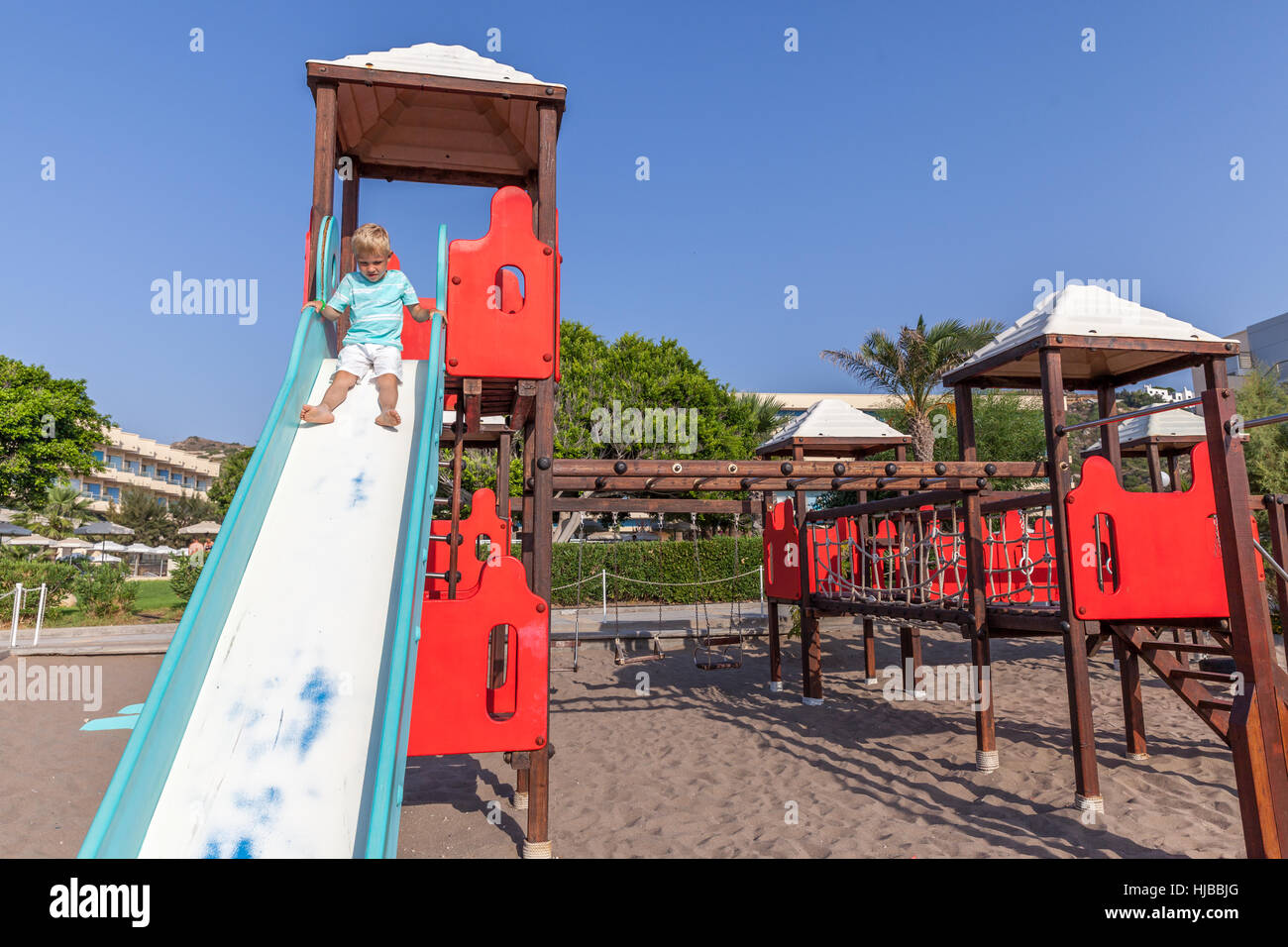 Happy smiling child in small house on playground Stock Photo - Alamy