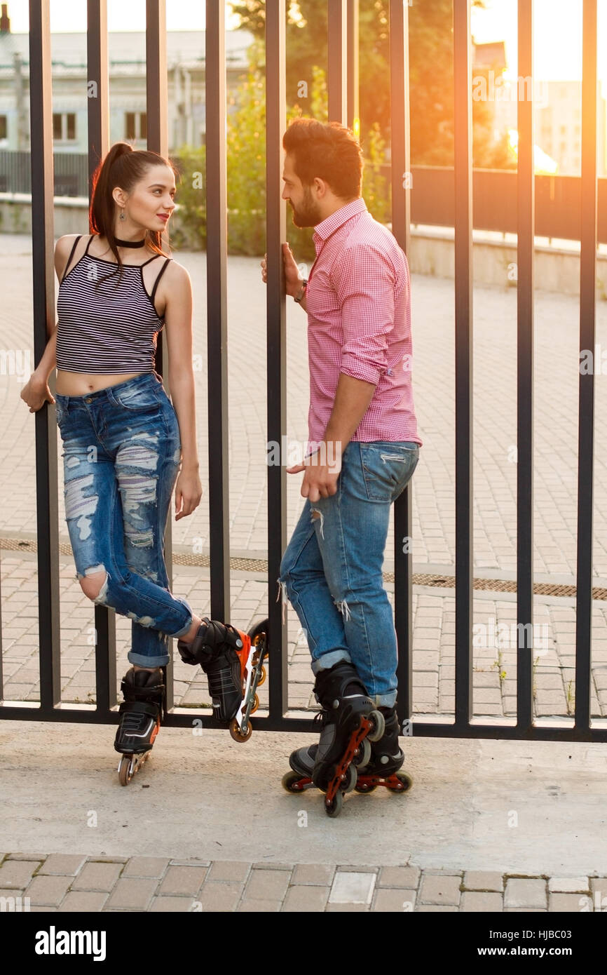 Couple on inline skates standing Stock Photo - Alamy