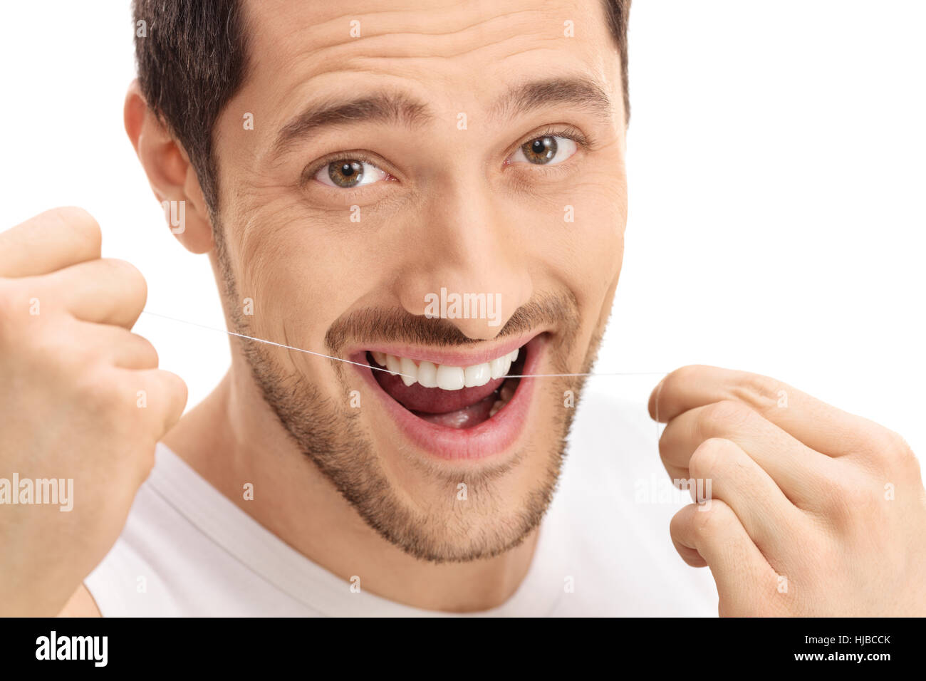 Man flossing his teeth isolated on white background Stock Photo - Alamy