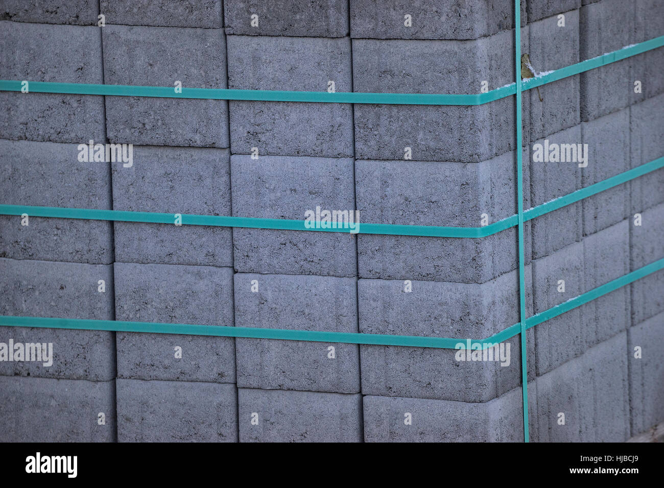 Construction bricks held through a steel belt Stock Photo - Alamy