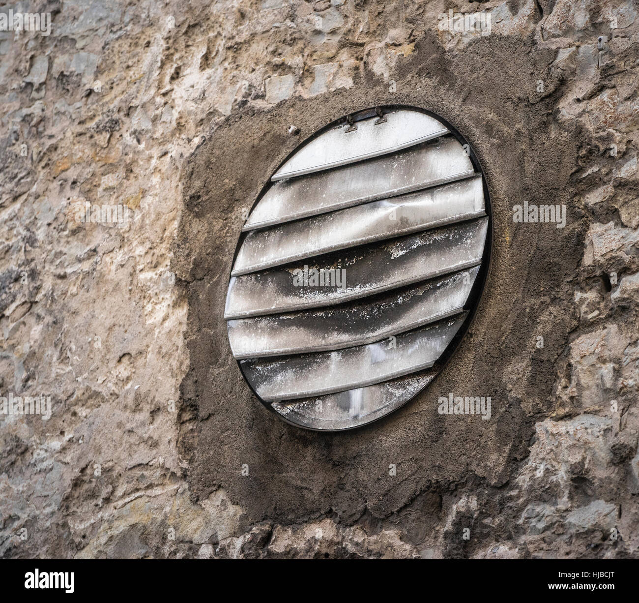 Dented grey ventilation exit on a wall Stock Photo - Alamy