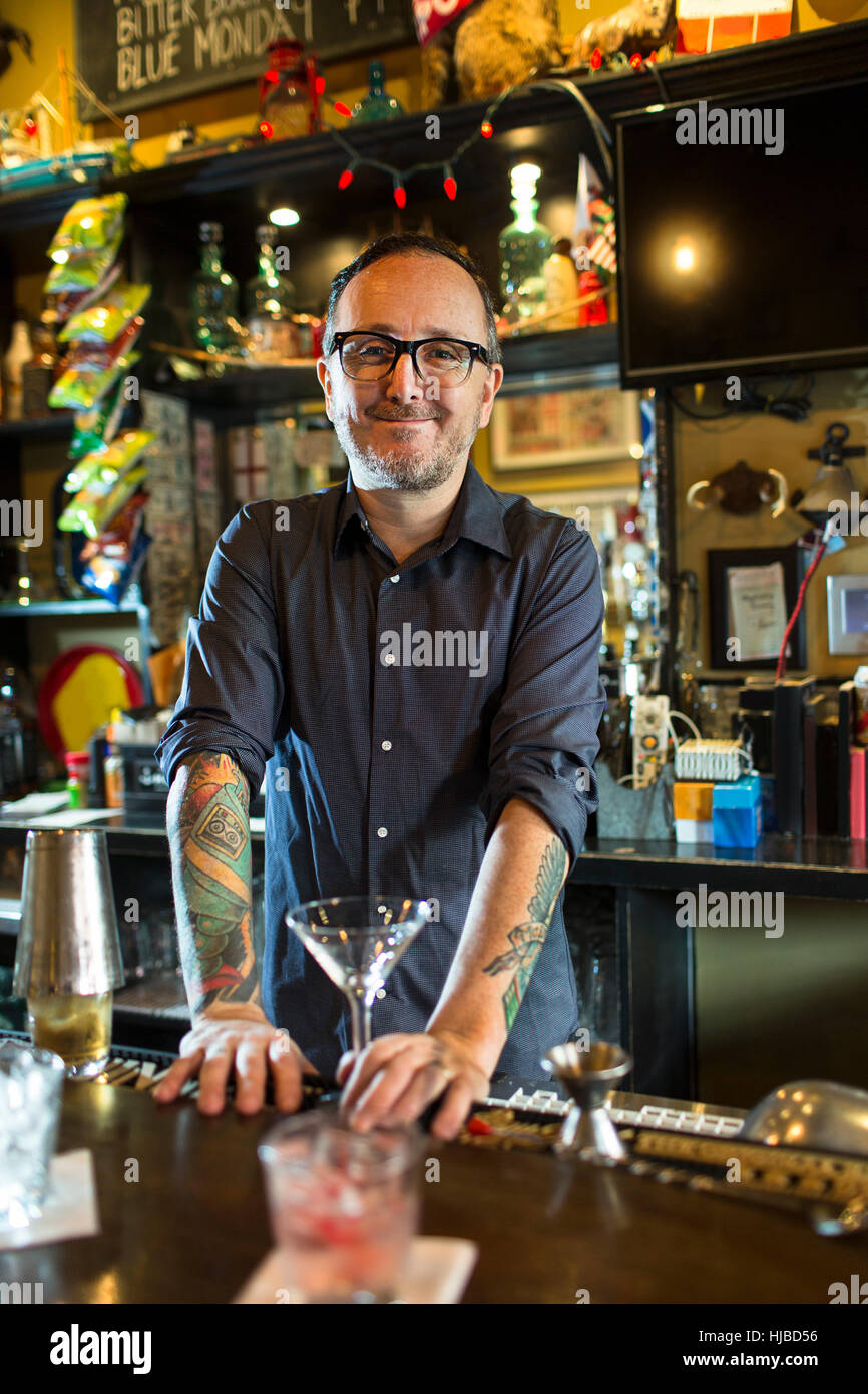 Portrait of barman with cocktail glass at public house counter Stock ...