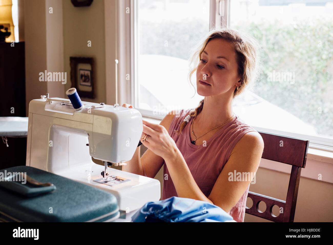 Woman threading sewing machine Stock Photo - Alamy