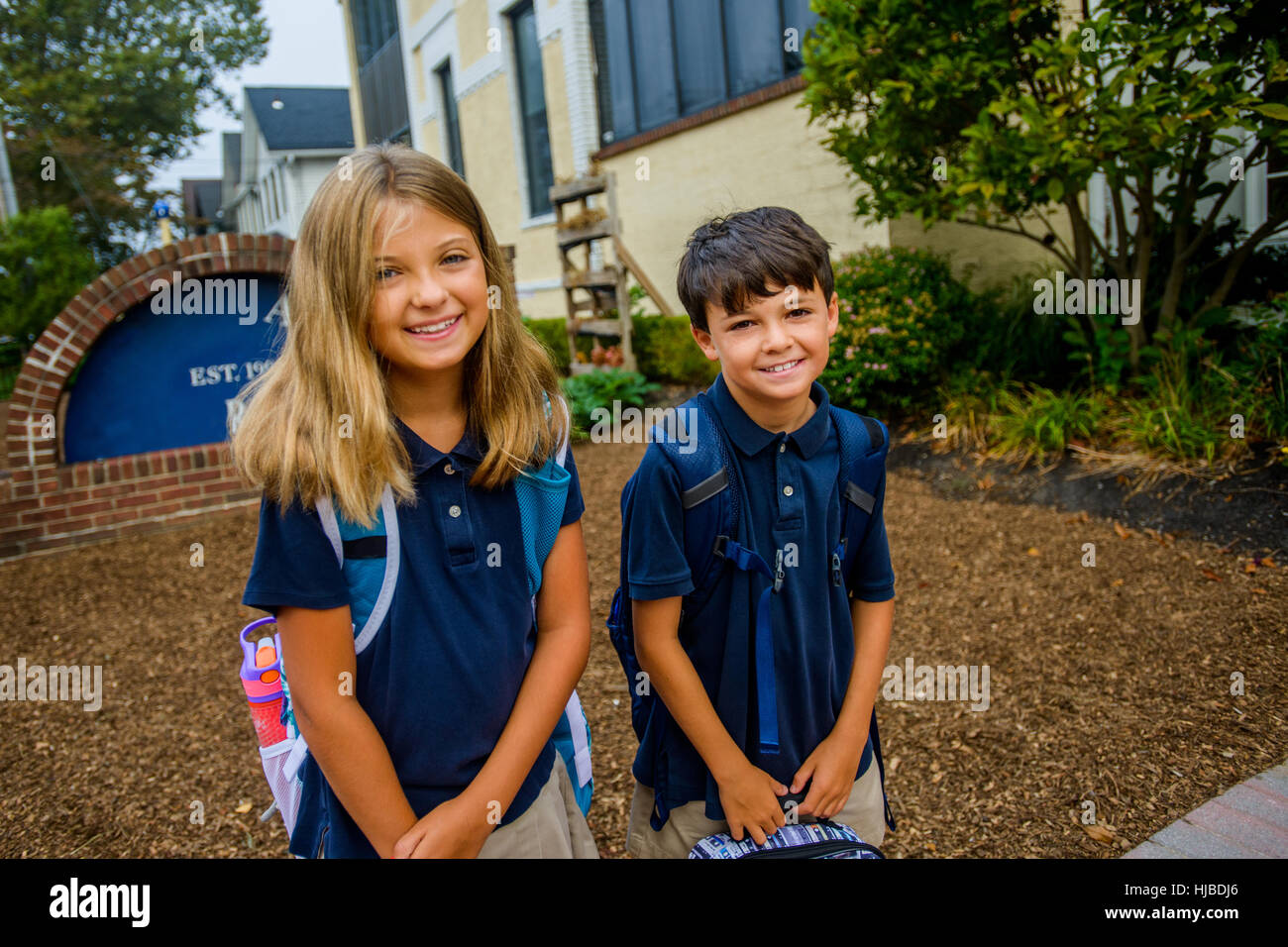 Portrait of male and female twins outside elementary school Stock Photo ...