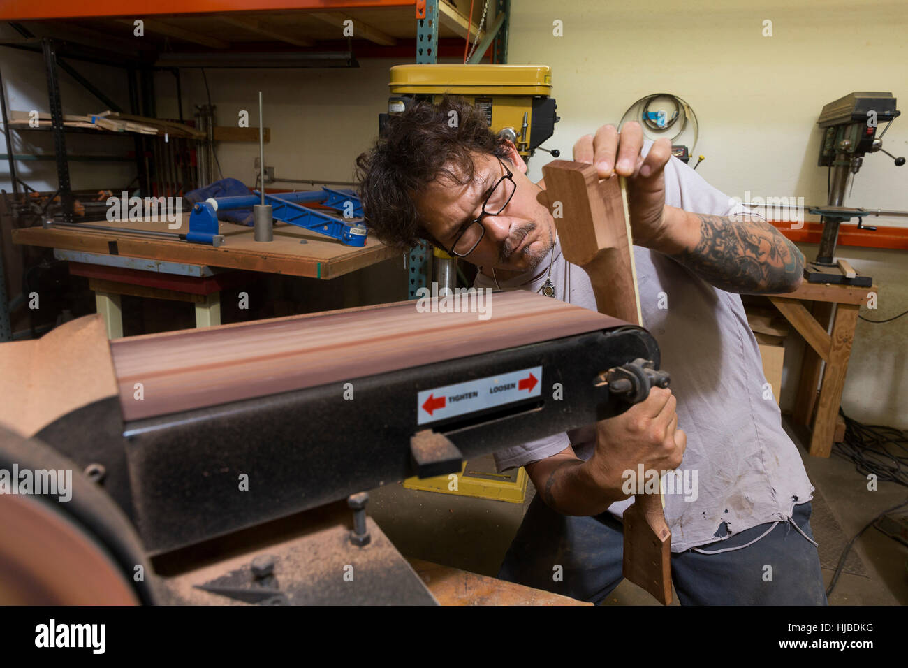 Guitar maker manufacturing guitar in workshop Stock Photo - Alamy