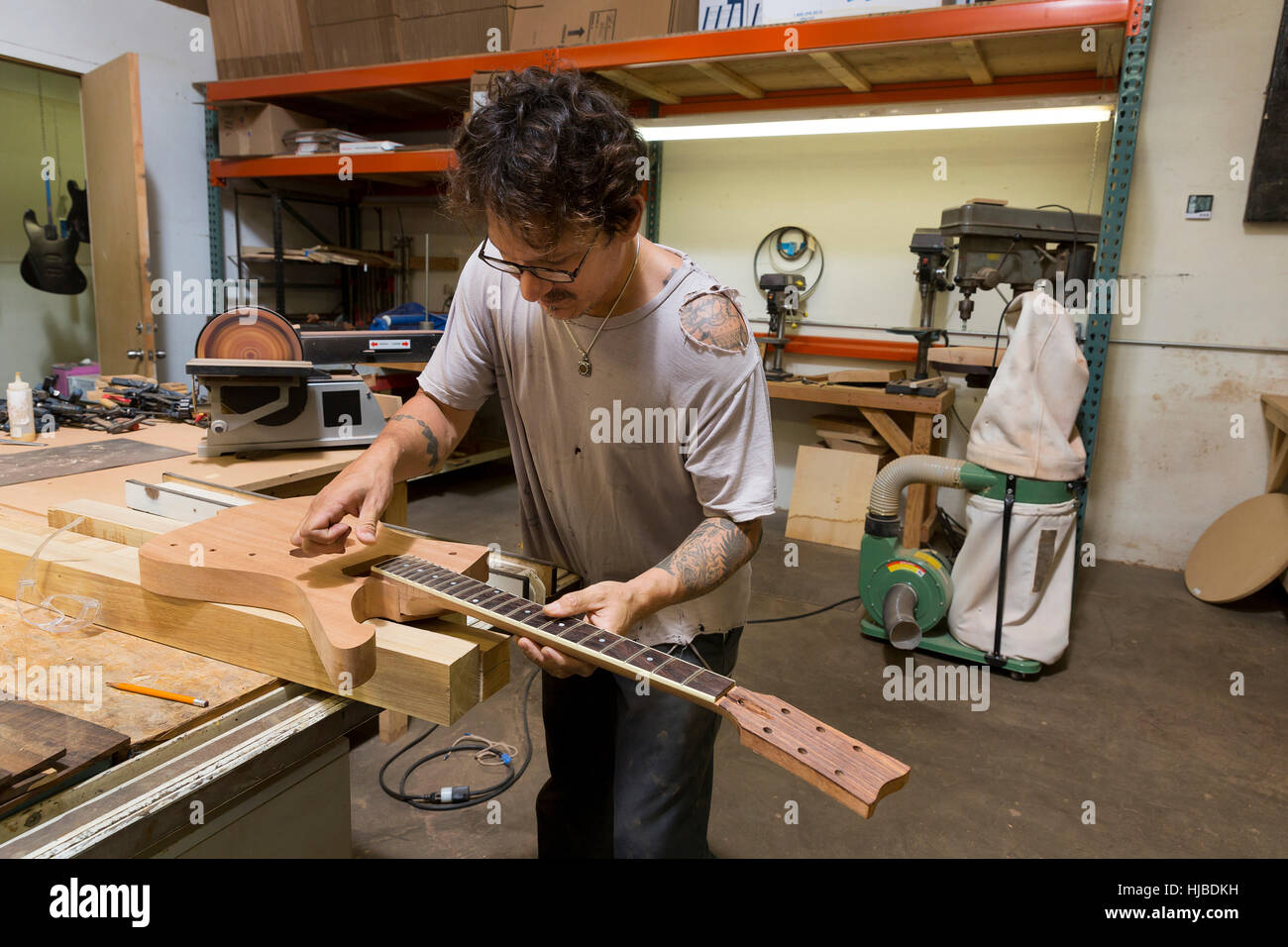 Guitar maker manufacturing guitar in workshop Stock Photo - Alamy