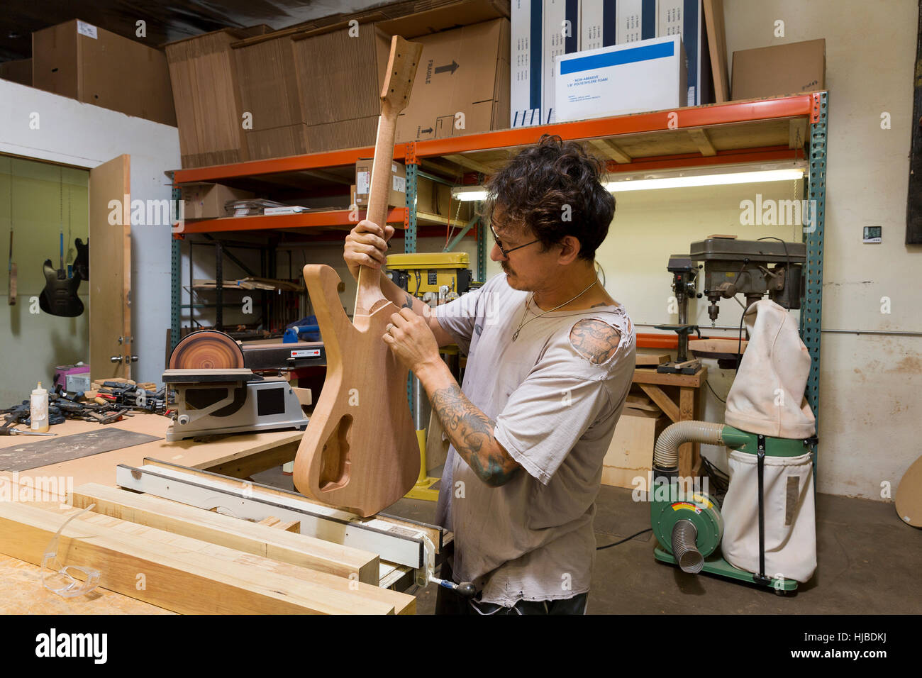Guitar maker manufacturing guitar in workshop Stock Photo - Alamy