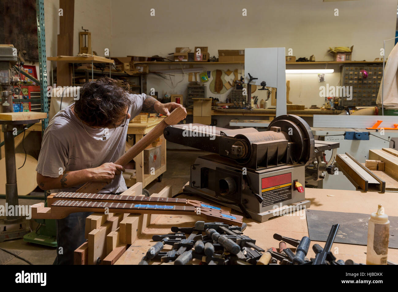Guitar maker manufacturing guitar in workshop Stock Photo - Alamy