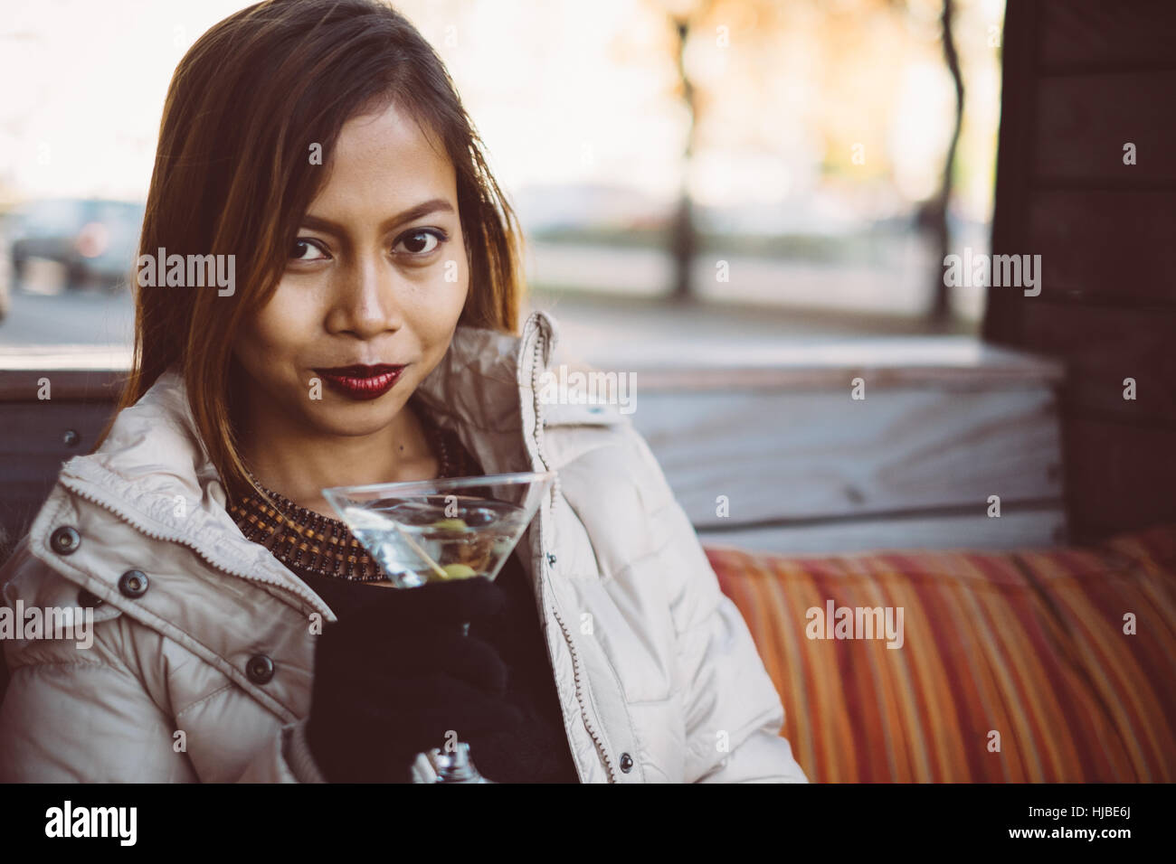 Beautiful adult girl drinking Martini outdoor , early spring Stock ...
