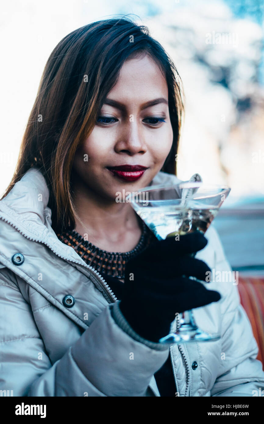 Beautiful adult girl drinking Martini outdoor , early spring Stock ...