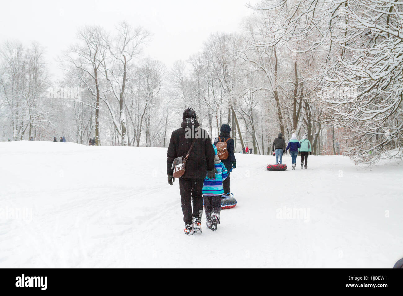 People walk in winter Park in the snow Stock Photo - Alamy