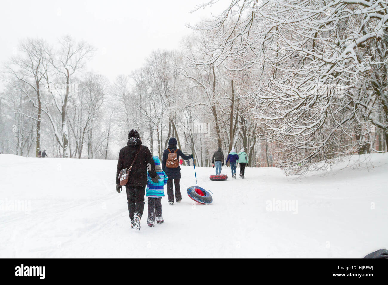 People walk in winter Park in the snow Stock Photo - Alamy