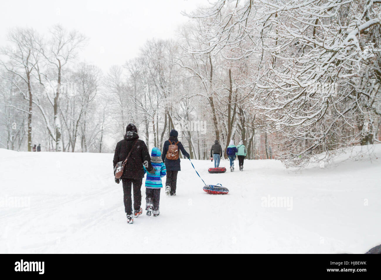 People walk in winter Park in the snow Stock Photo - Alamy