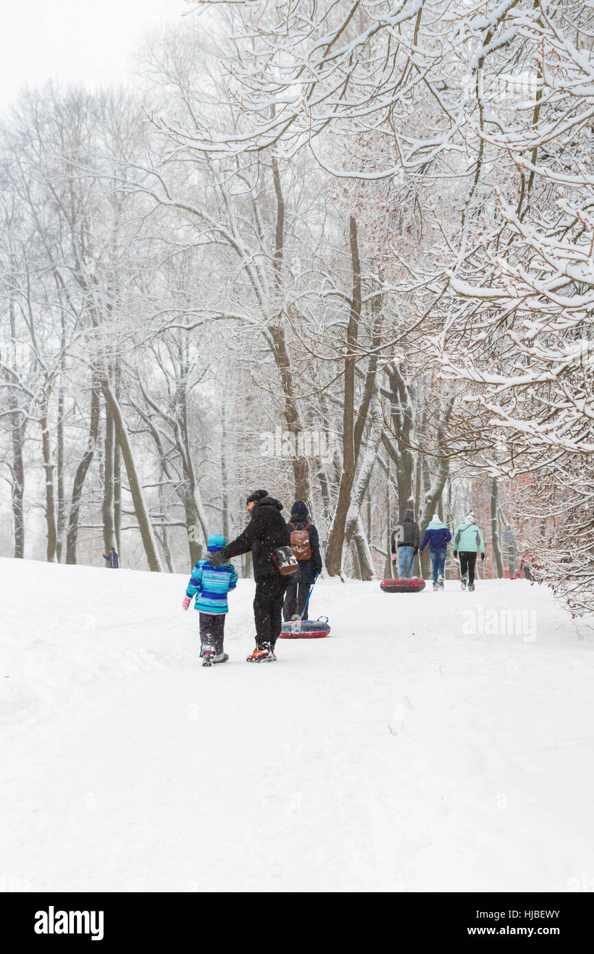 People walk in winter Park in the snow Stock Photo - Alamy