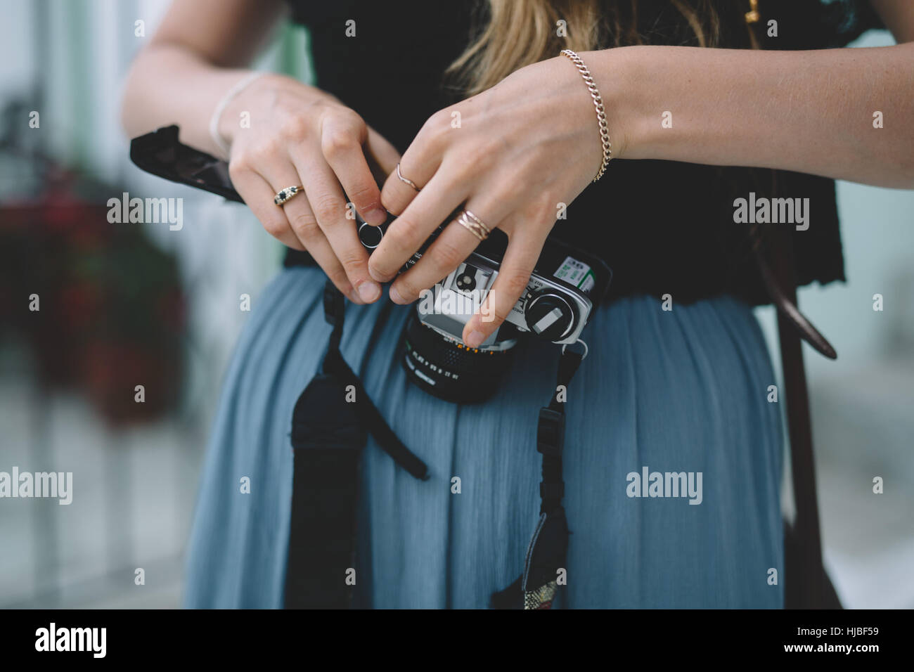 Girl loads film into camera Stock Photo - Alamy