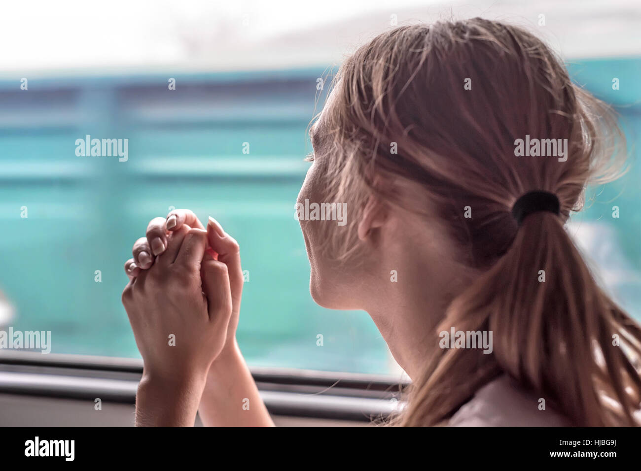 Beautiful young woman travelling in a train Stock Photo - Alamy